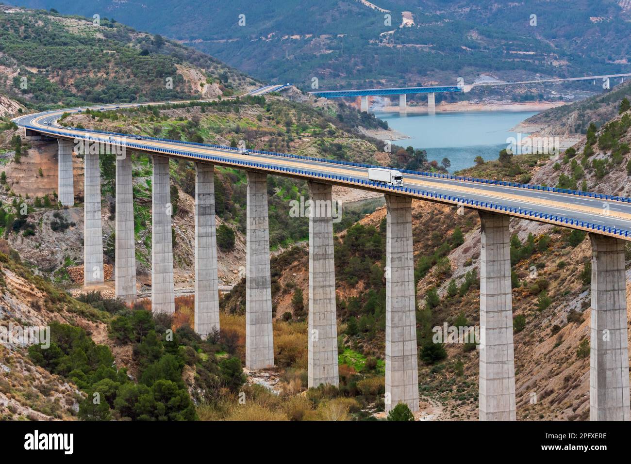 Refrigerated truck driving on a highway with bridges over a swamp, road ...