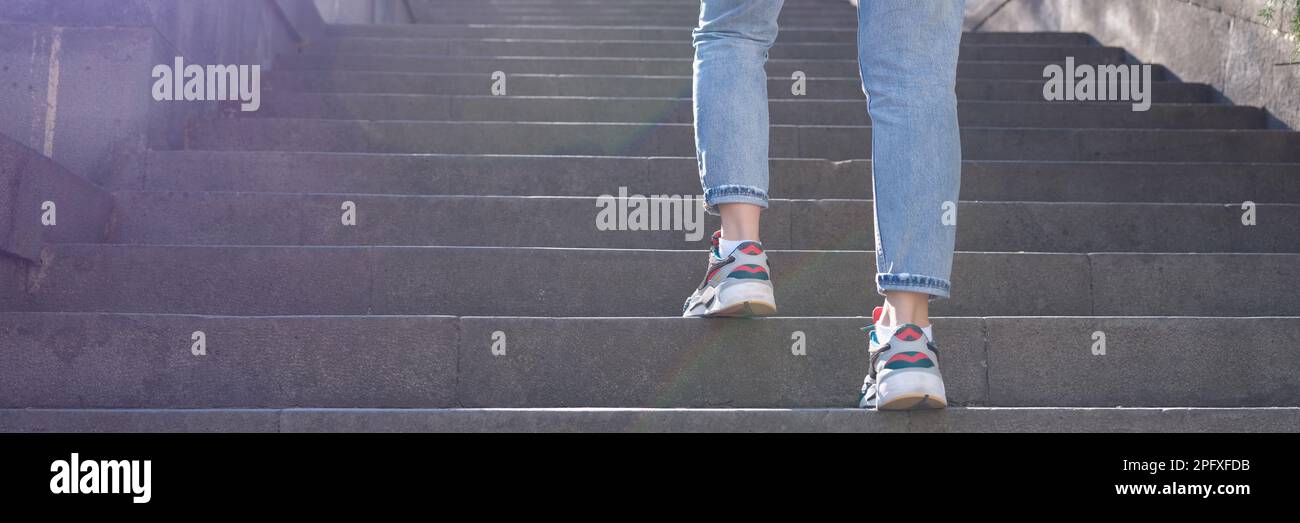 Woman climbing stairs jeans hi-res stock photography and images - Alamy