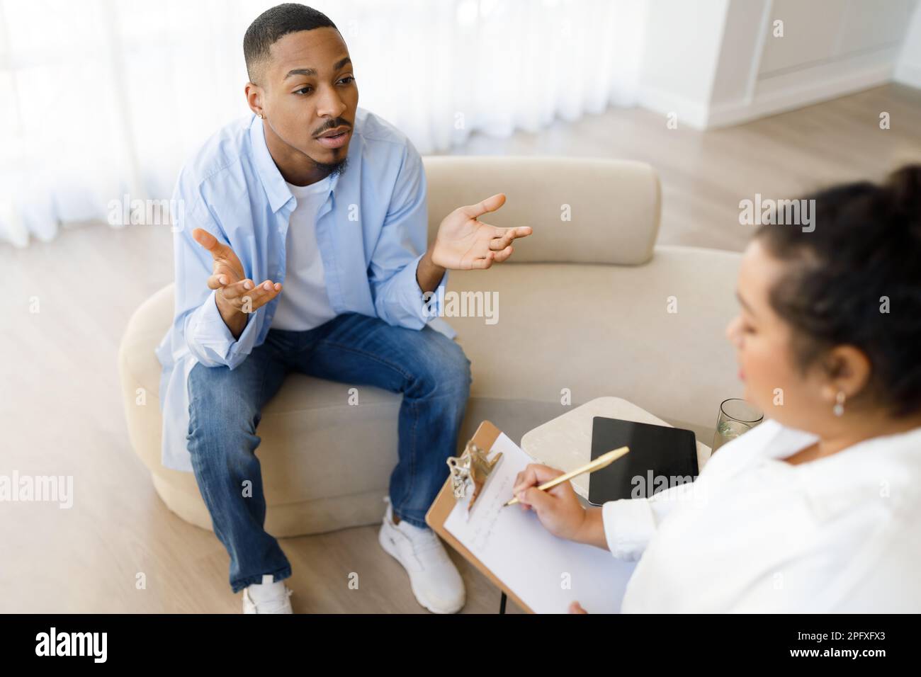 African man have therapy session with hispanic woman psychologist Stock ...