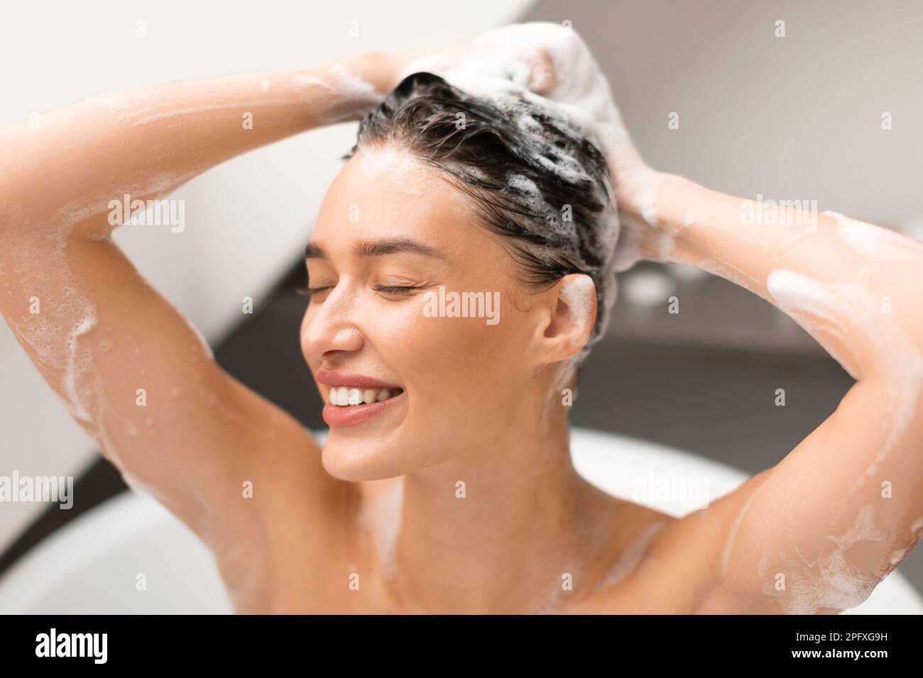 Happy Lady Washing Head Caring For Long Hair In Bathroom Stock Photo ...