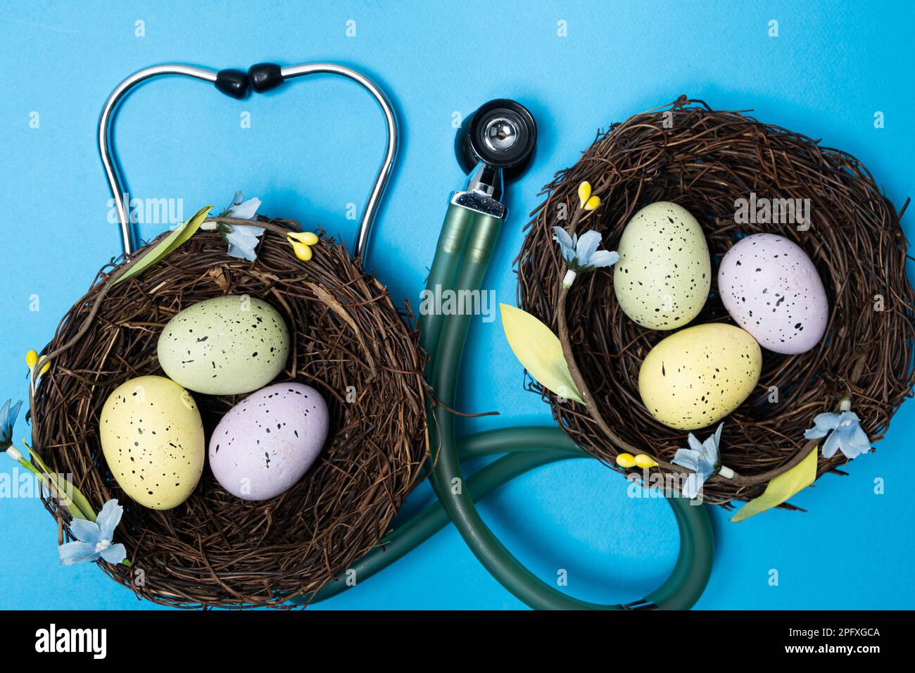 Easter Medicine. Two nests with painted eggs and a stethoscope on a ...