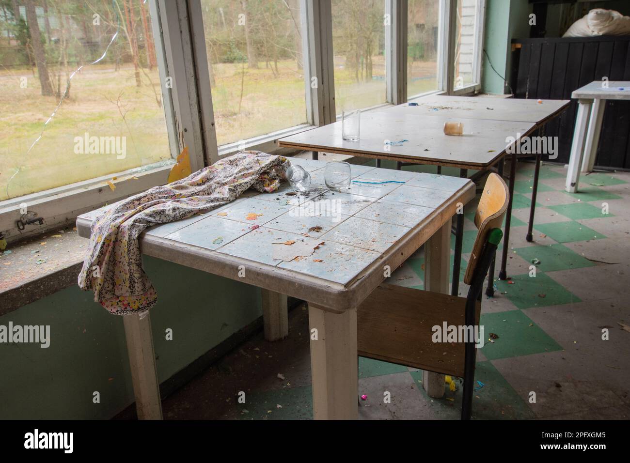 Old, dilapidated tables and coffee tables in an abandoned building ...