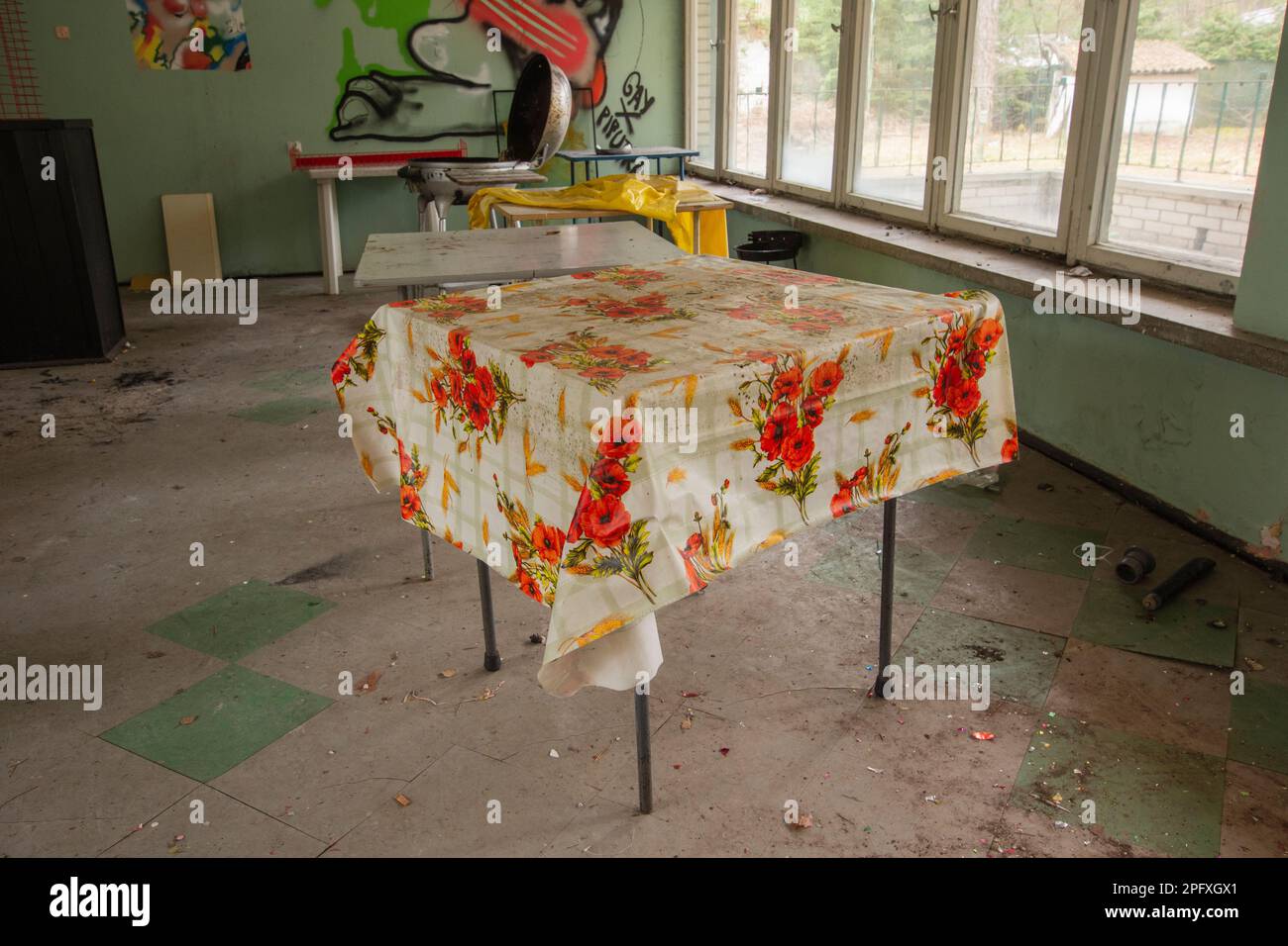 Old, dilapidated tables and coffee tables in an abandoned building ...