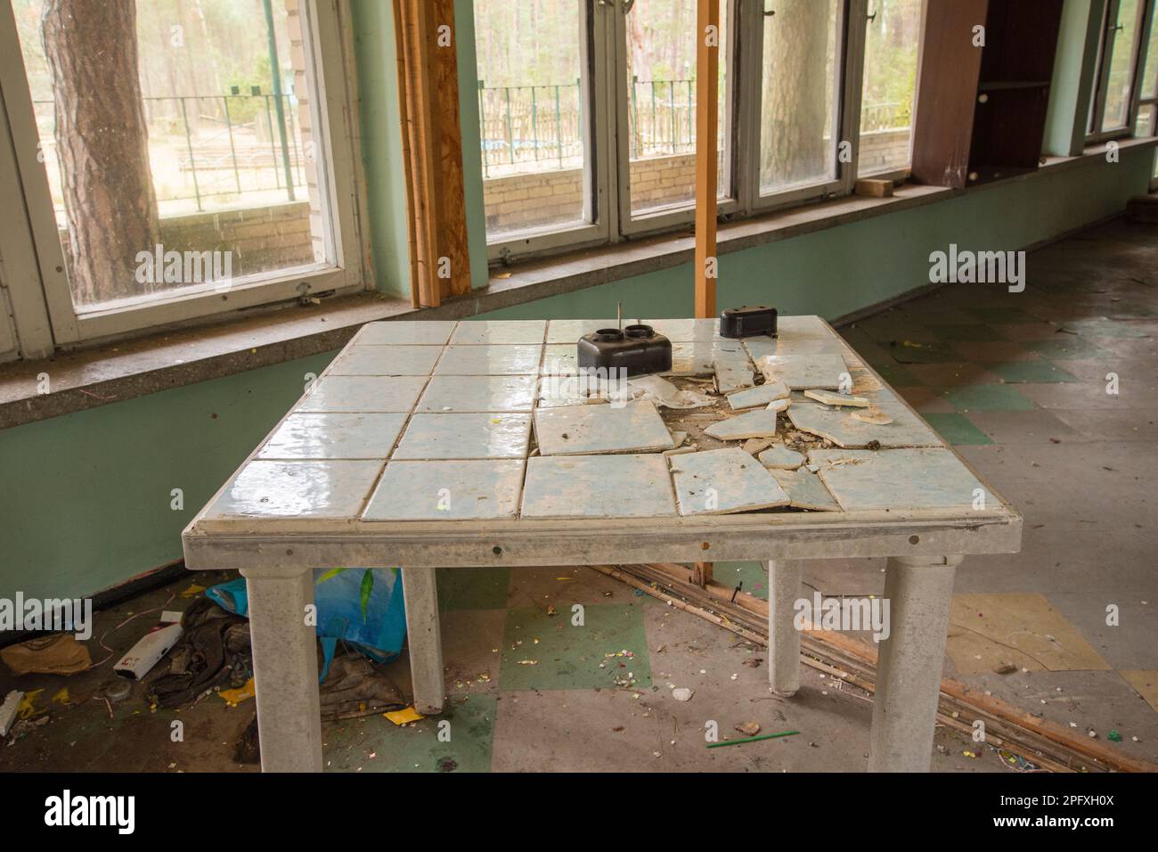 Old, dilapidated tables and coffee tables in an abandoned building ...