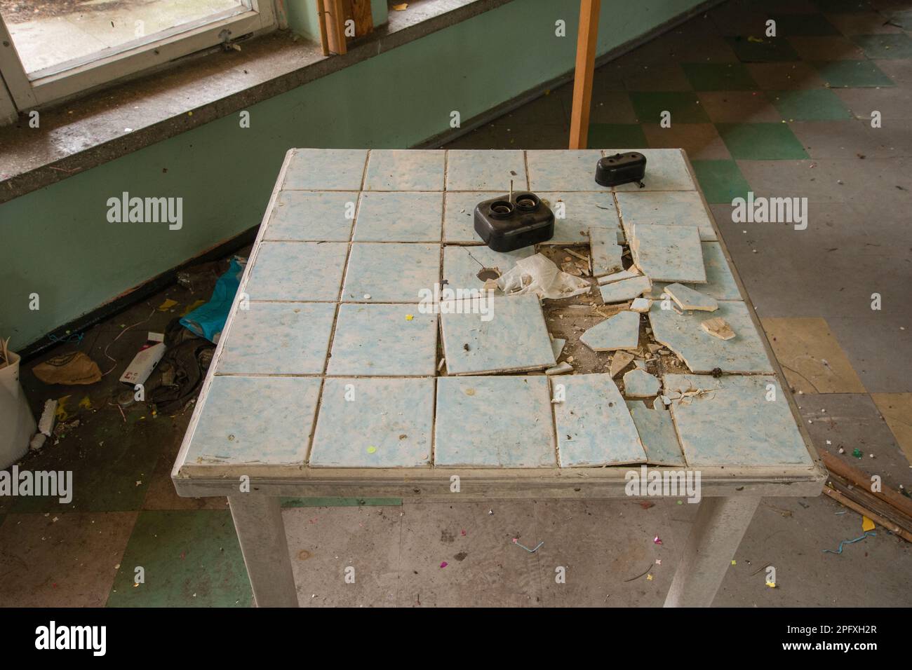 Old, dilapidated tables and coffee tables in an abandoned building ...