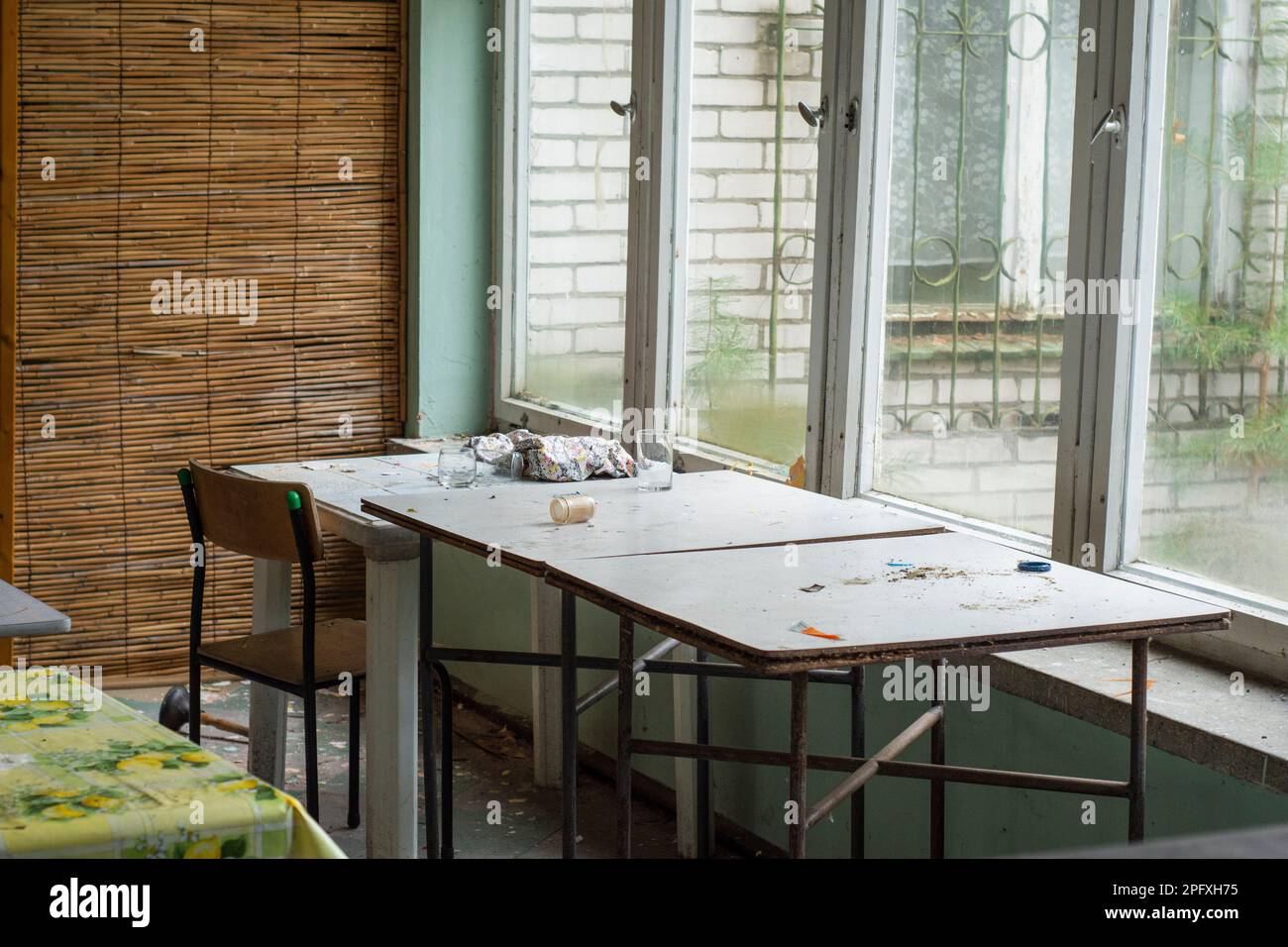 Old, dilapidated tables and coffee tables in an abandoned building ...