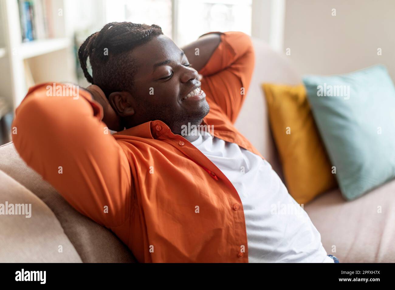 Positive black man reclining hi-res stock photography and images - Alamy