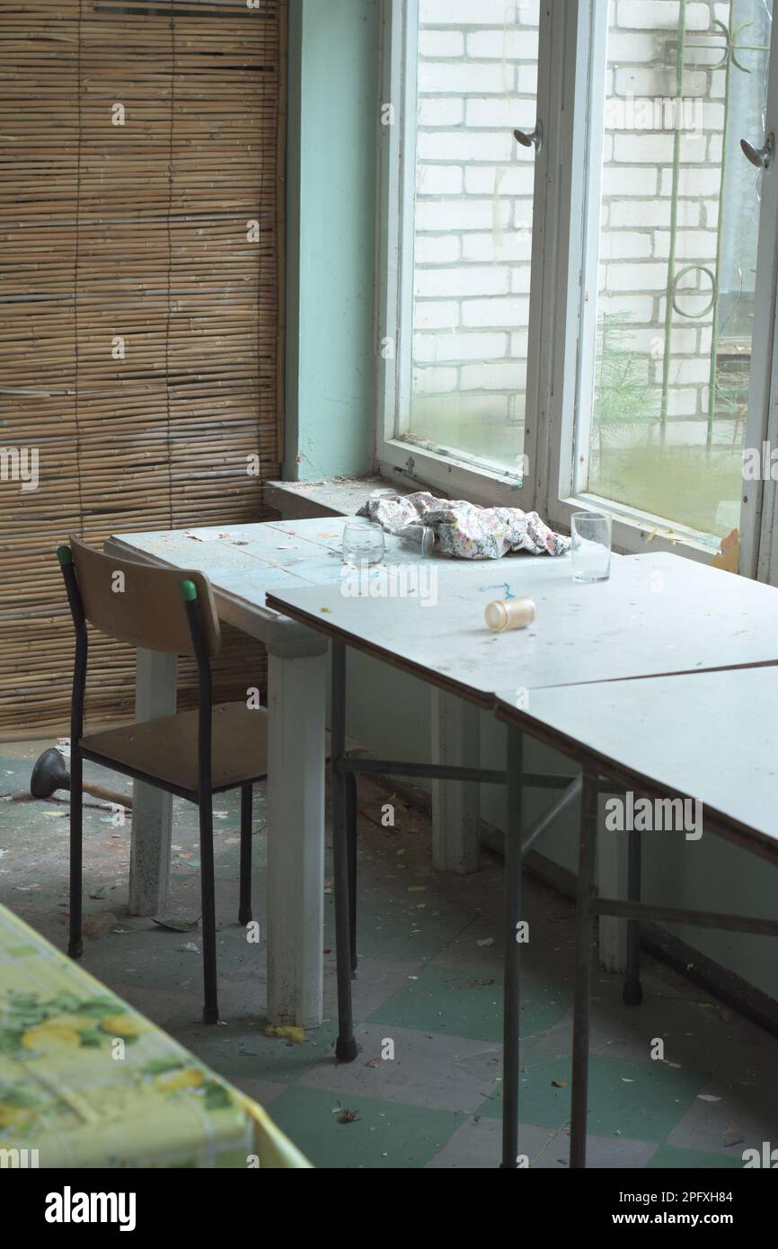 Old, dilapidated tables and coffee tables in an abandoned building ...