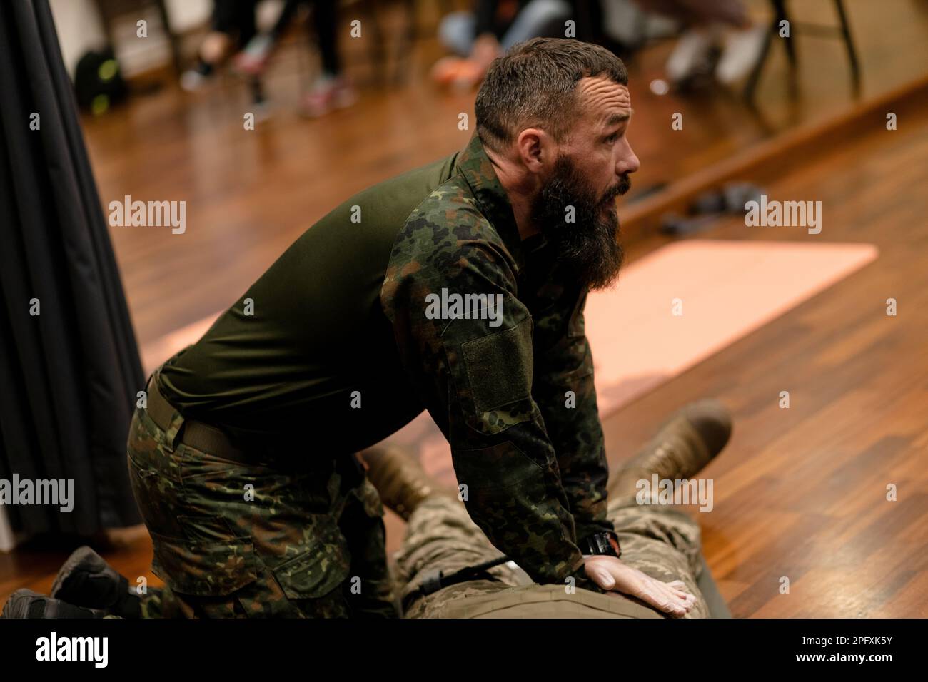 A 40-year-old bearded military medic demonstrates how he applies hand ...