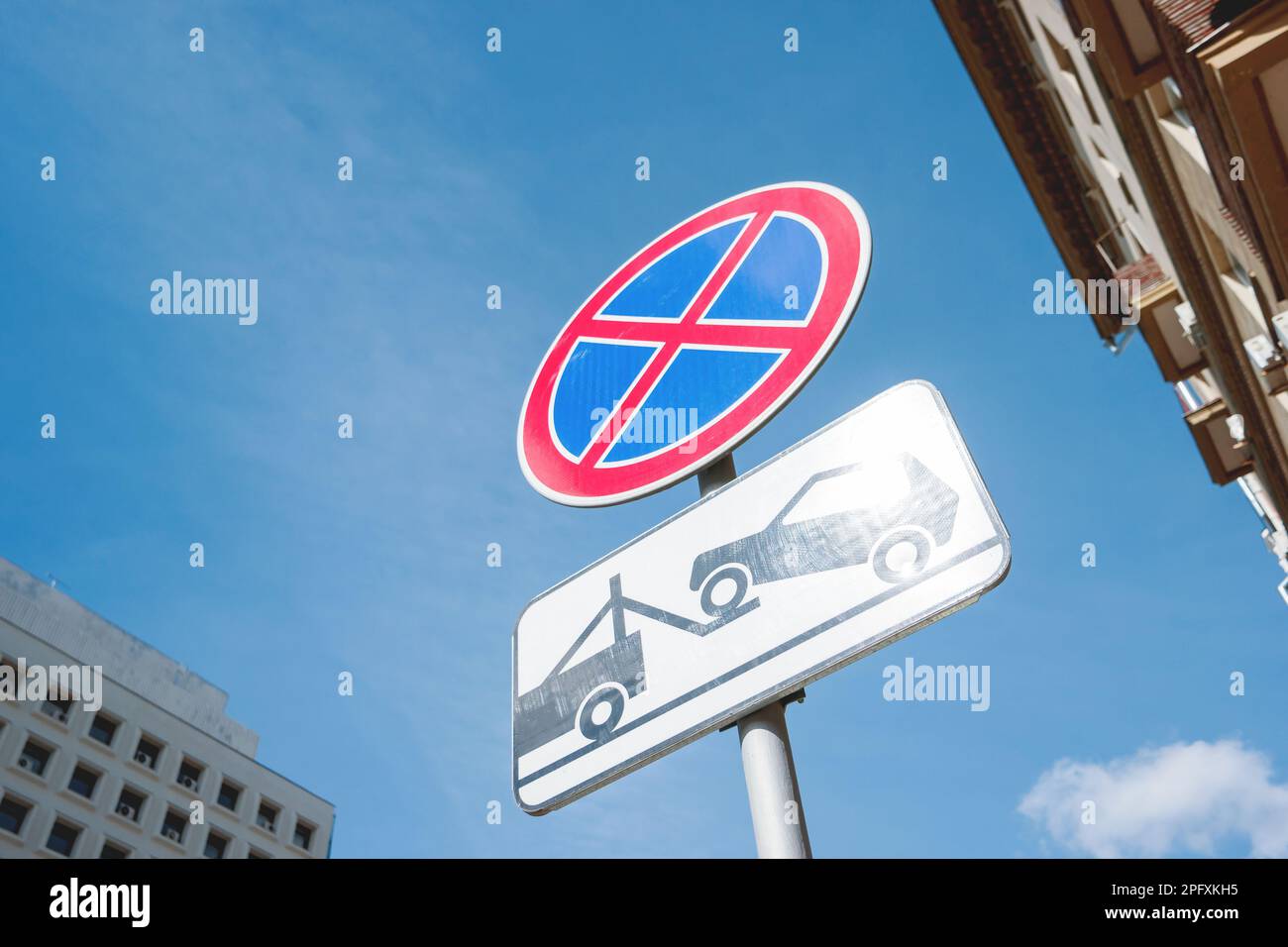 Street signs - "Parking is prohibited" and "Tow truck" - on blue sky ...