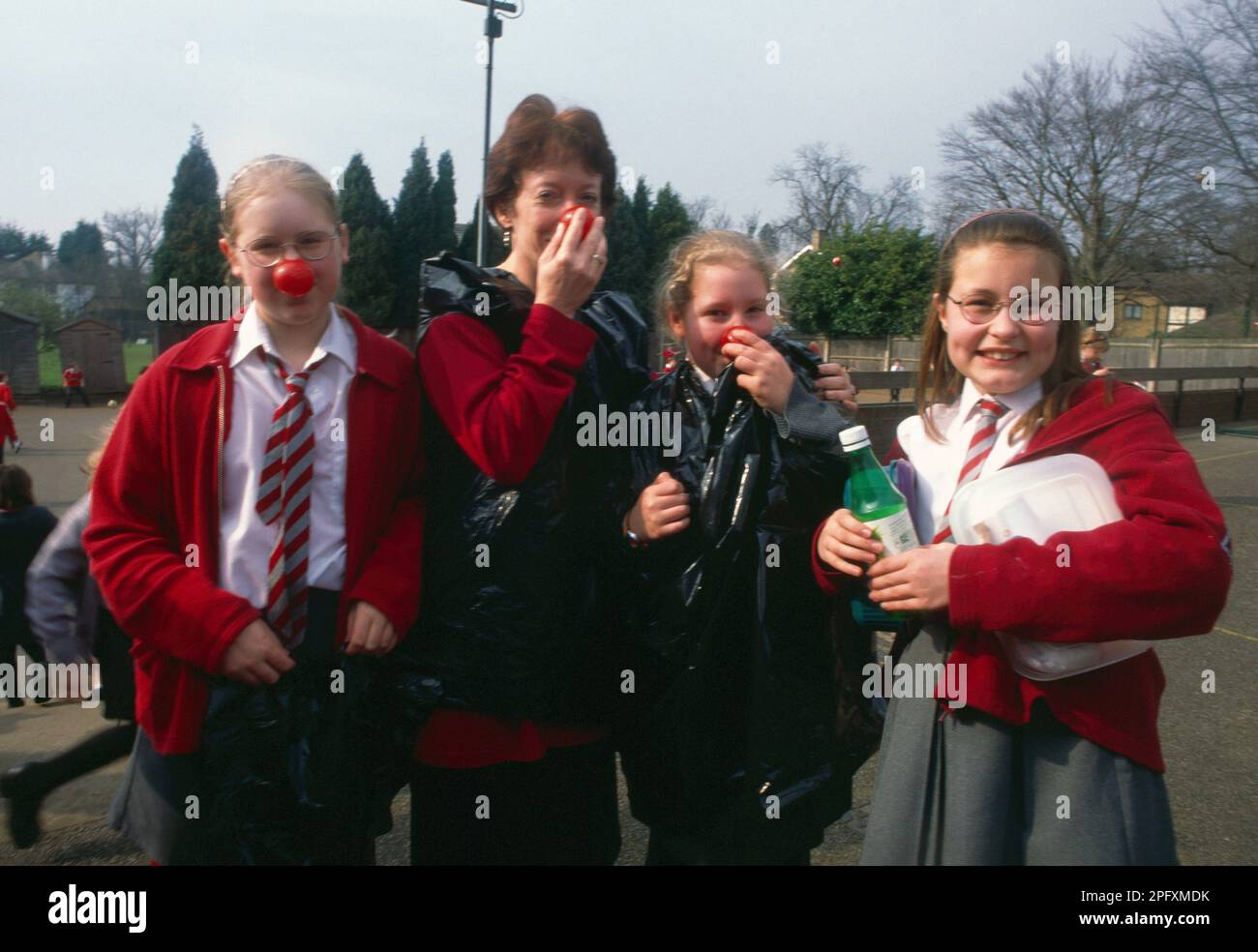 Children with Teacher Wearing Red Noses For Comic Relief In School ...