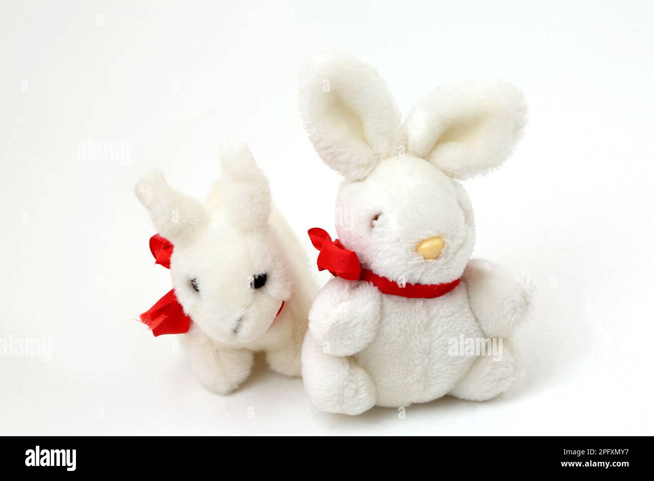 Two White Soft Rabbits with Red Bows Stock Photo - Alamy