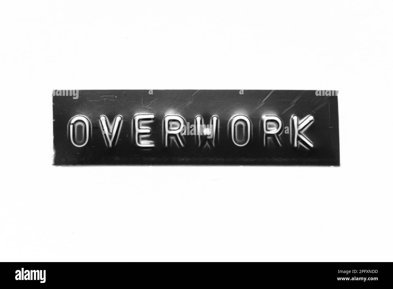 Black color banner that have embossed letter with word overwork on ...