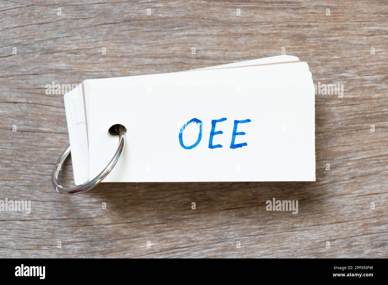 Flash card with handwriting in word OEE (abbreviation of overall ...