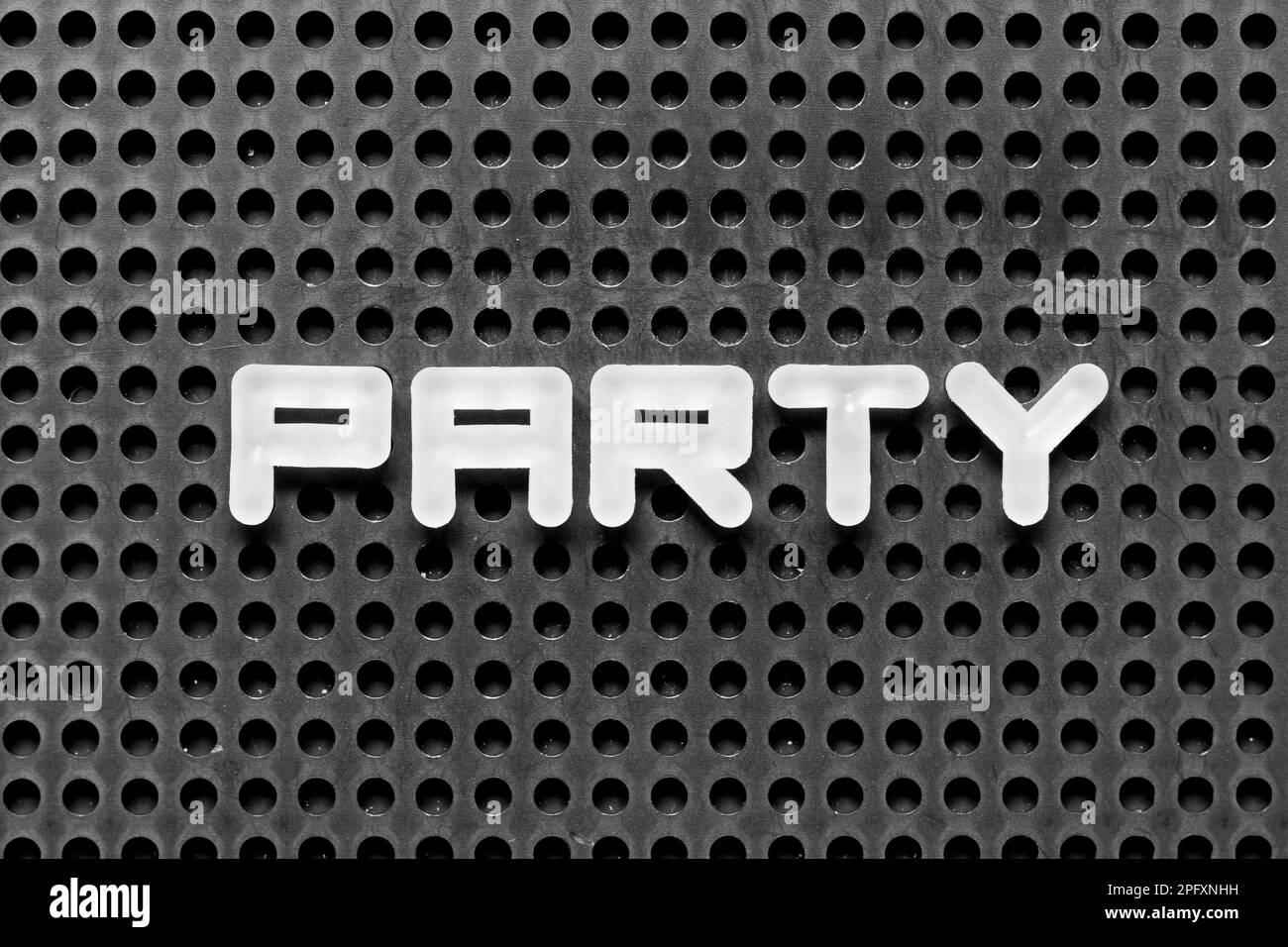 White alphabet letter in word party on black pegboard background Stock ...