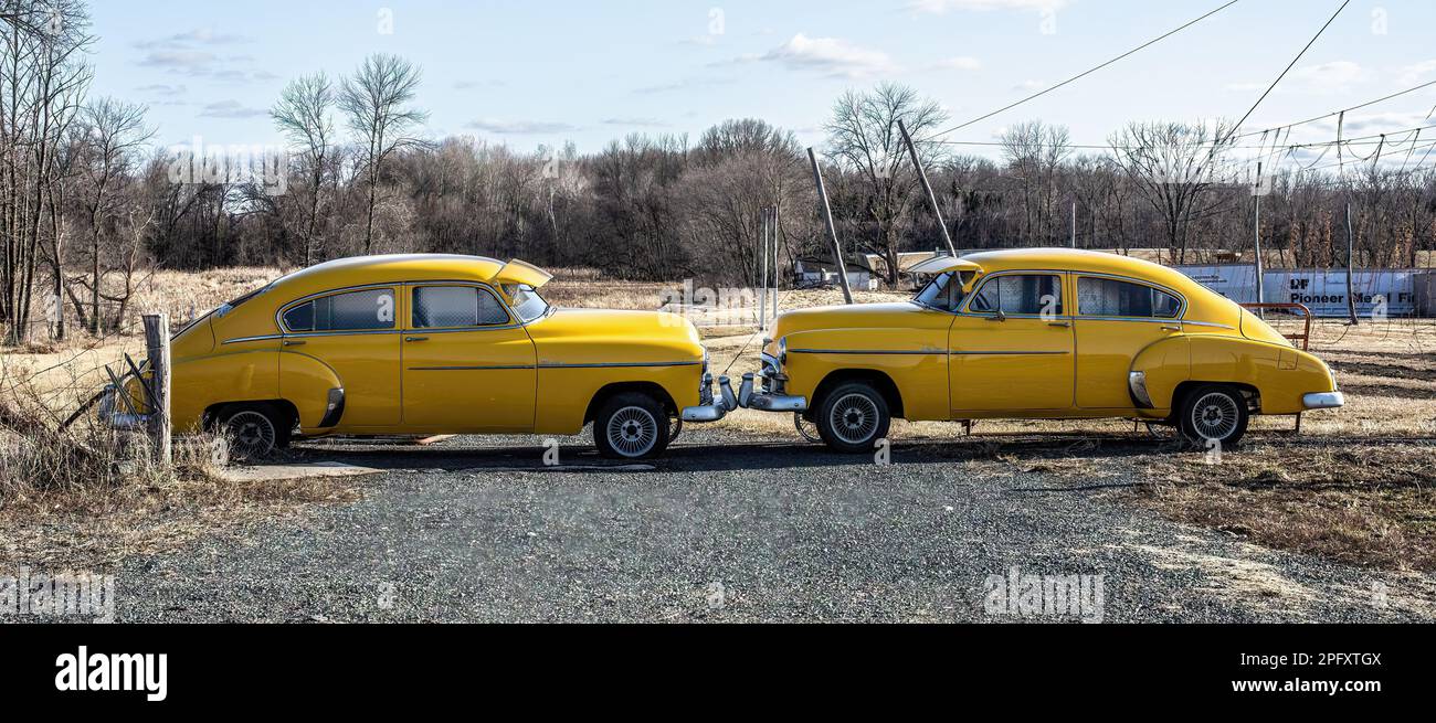 Two halves of a 49 Chevolet Deluxe 4-door on a track that closes a gate ...
