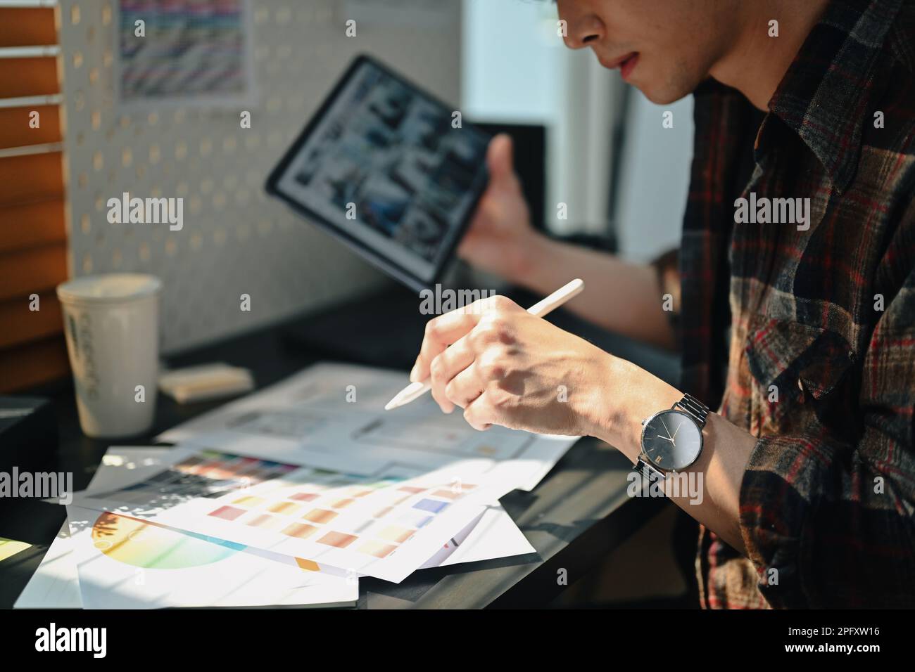 Interior designer holding digital tablet working at project, choosing ...