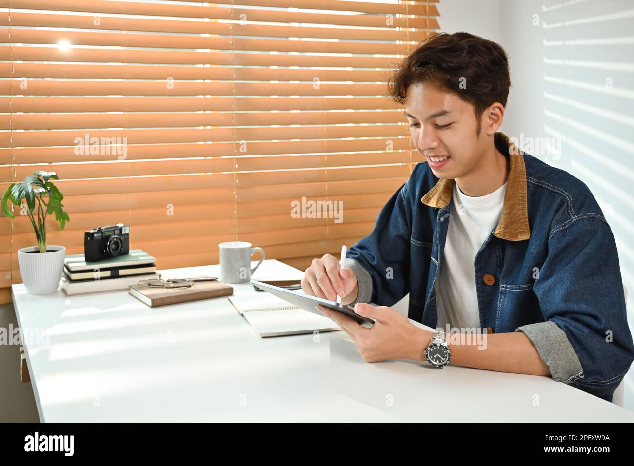 Attractive adult man reading email or checking daily routine on digital ...