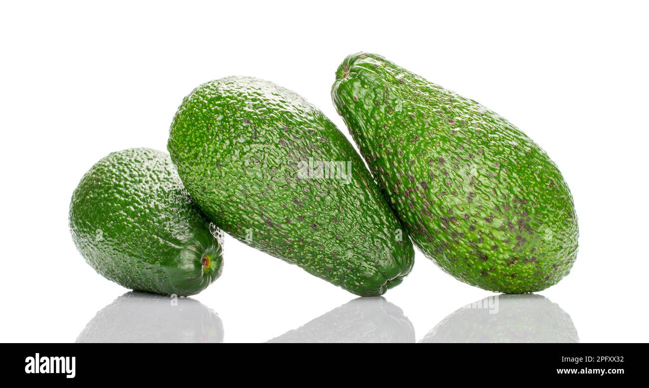 Three dark green ripe organic avocados, macro, isolated on white ...