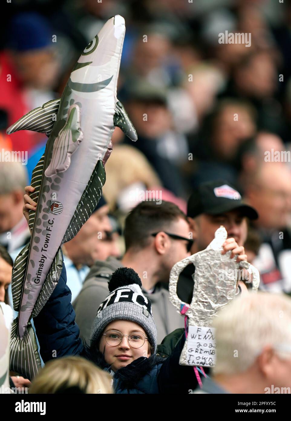 A Grimsby Town fan in the stands holds a Harry The Haddock ahead of the ...