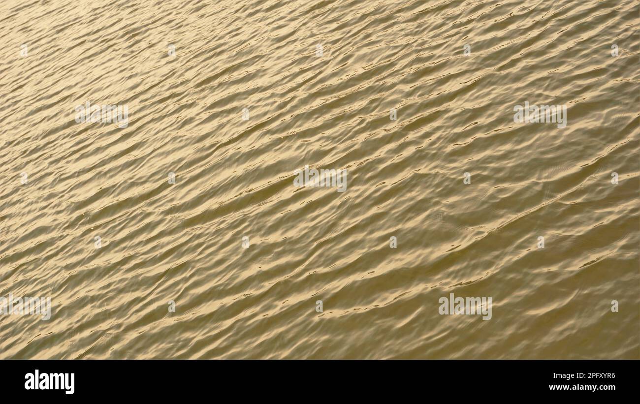 Beautiful natural wave pattern of water with reflection of bright sun ...