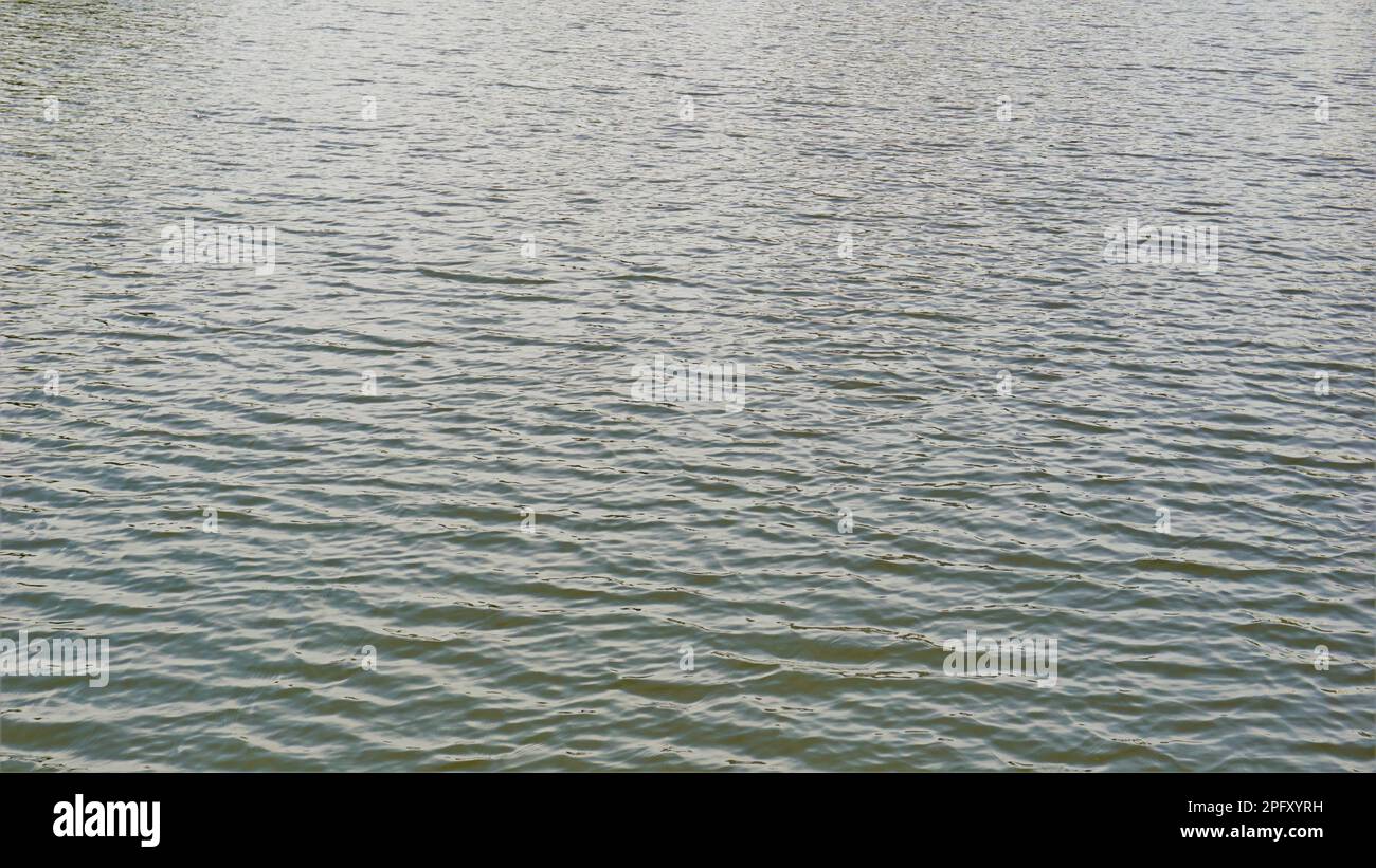 Beautiful natural wave pattern of water with reflection of bright sun ...