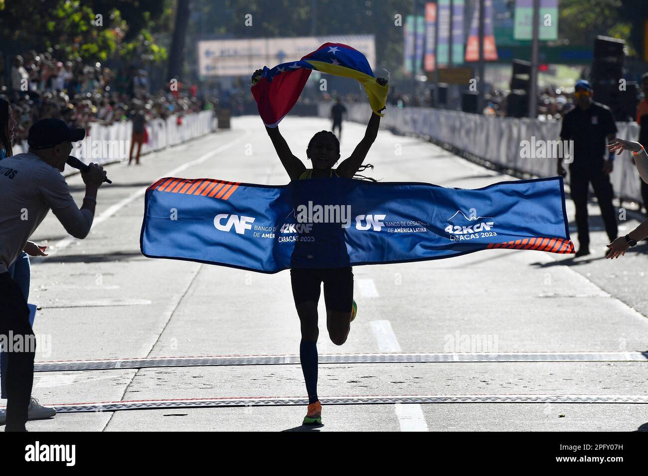 Venezuelan runner Magaly Garcia celebrates his first place holding a ...