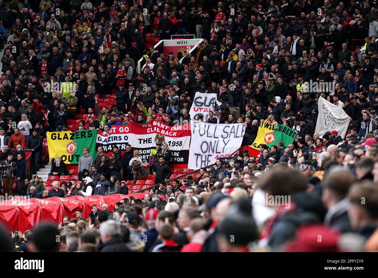 Manchester United fans with banners aimed at the club's owners are seen ...