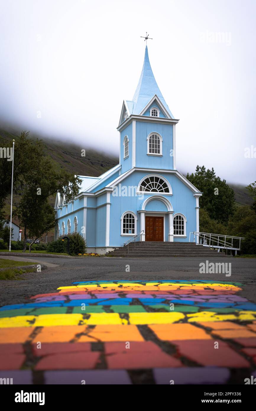 The rainbow stripes on pavement leading up to the Seydisfjordur Church ...
