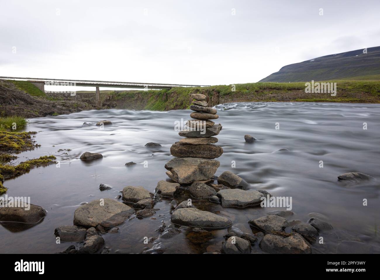 The rocks stacked into a tower by a stream, Kolugljufur Canyon, Iceland ...