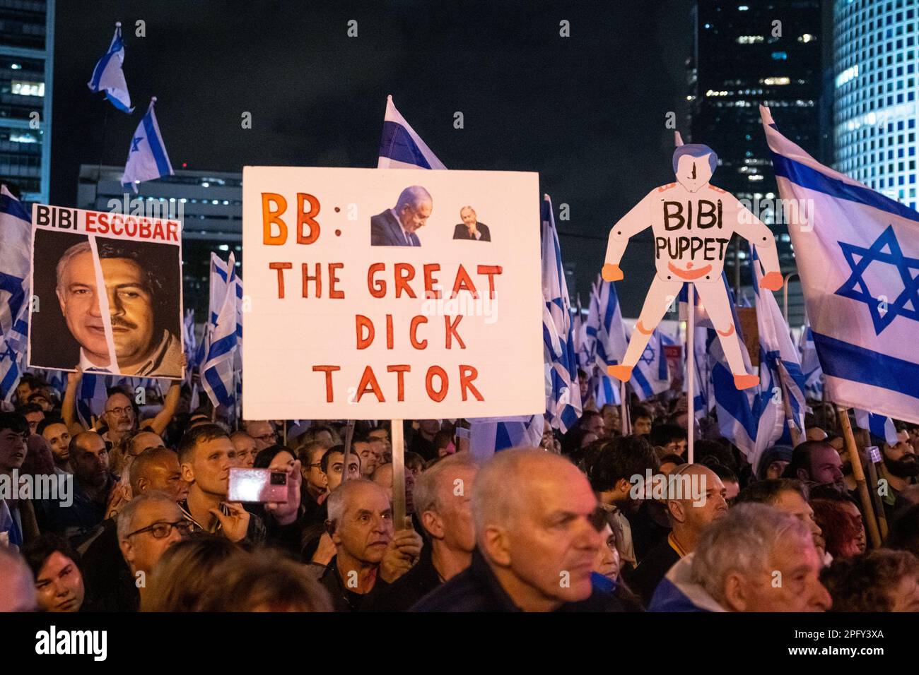 Israel. 18th Mar, 2023. Protestors wave the Israeli flag and signs with ...