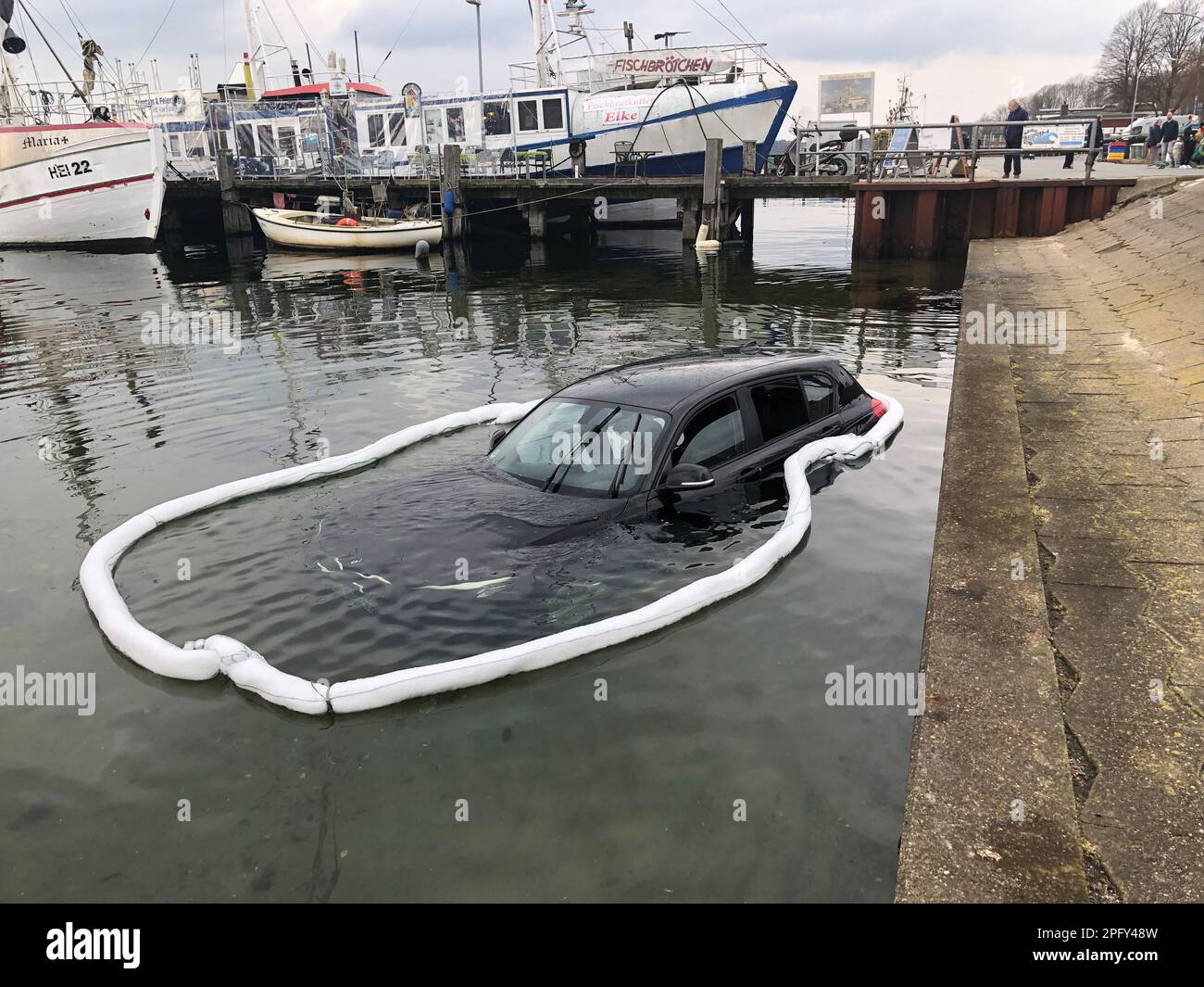 Heikendorf, Germany. 19th Mar, 2023. A car is half submerged in the ...