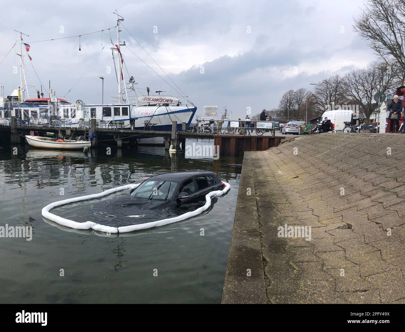 Heikendorf, Germany. 19th Mar, 2023. A car is half submerged in the ...