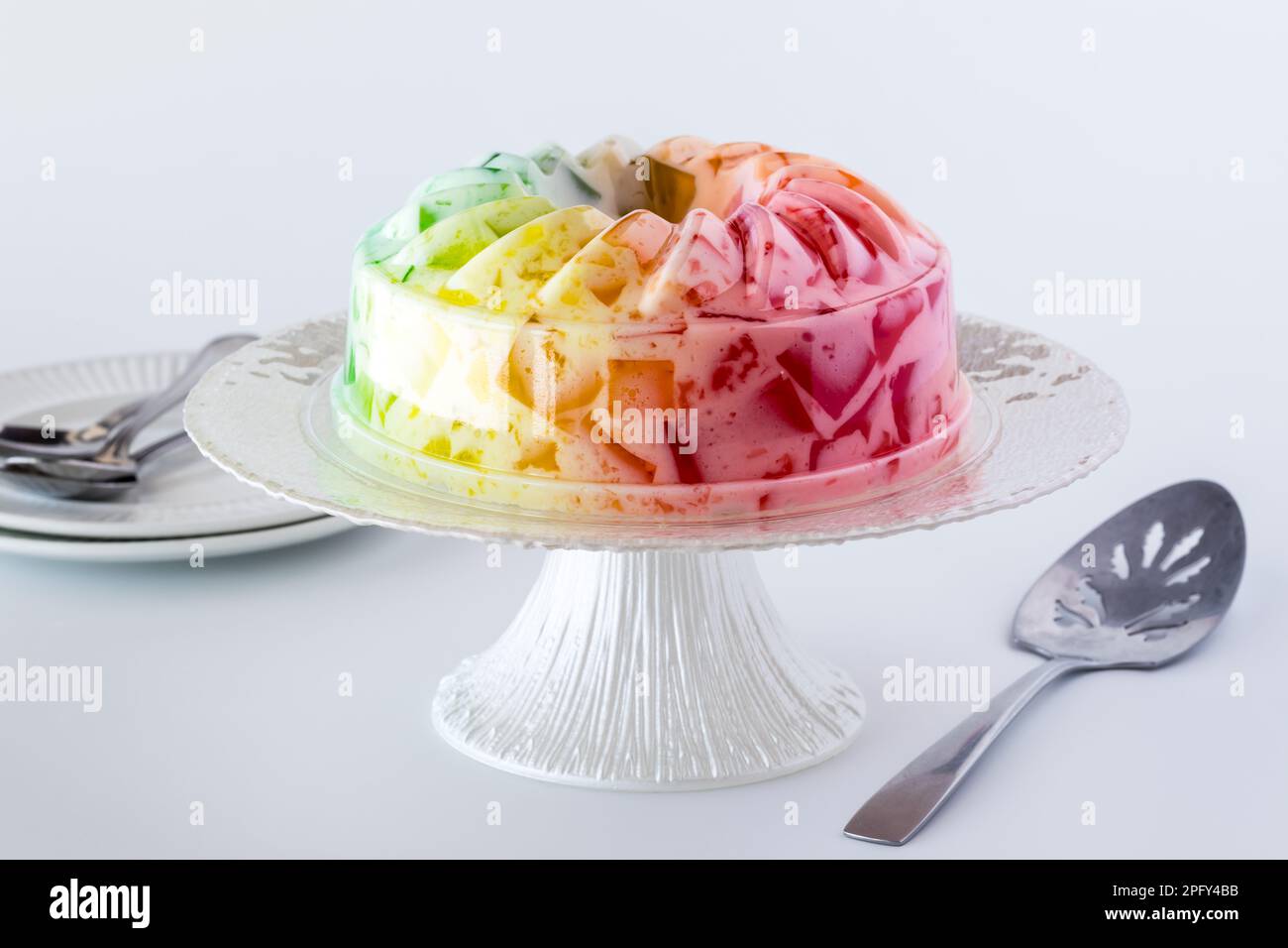 A colourful fruit flavoured jelly mold on a pedestal stand, ready for ...