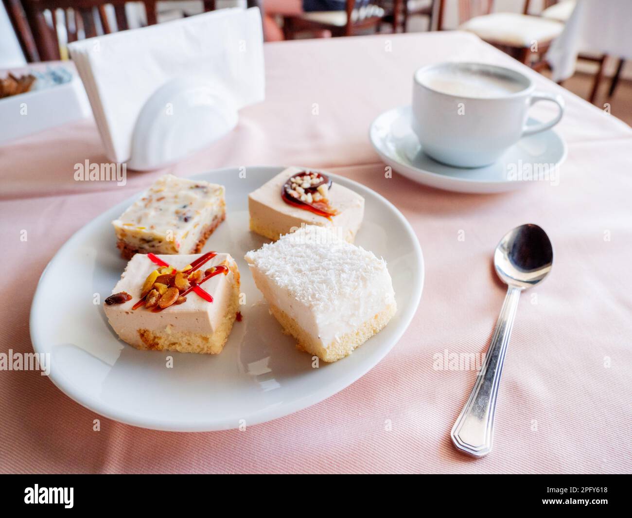 Breakfast in cafe - white cup with cappuccino and plate full of ...