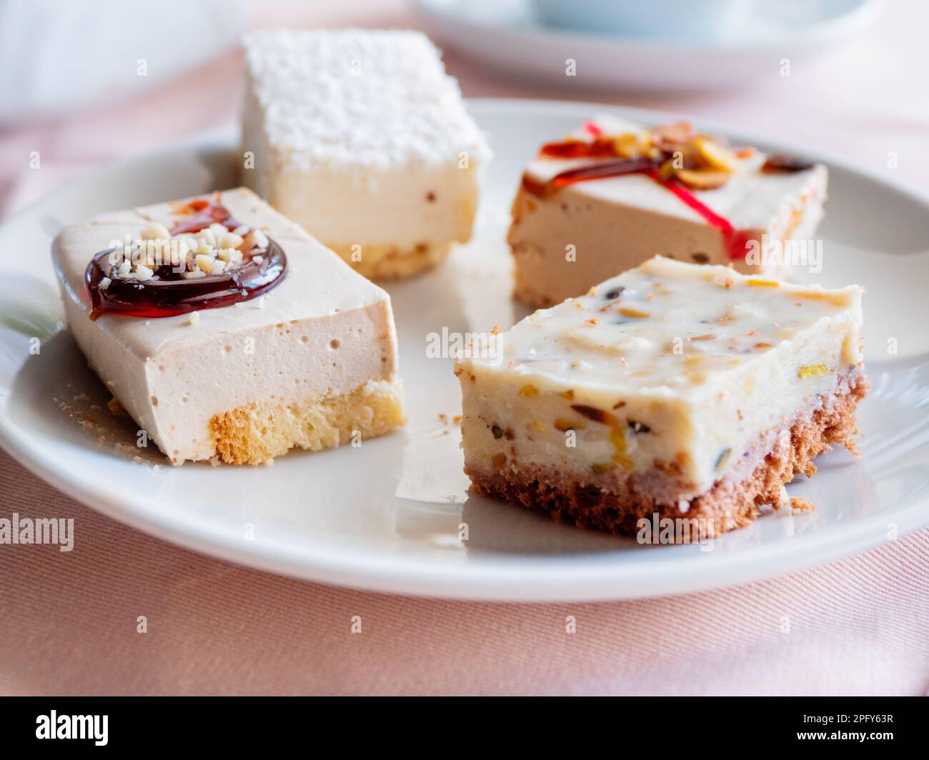 White plate full of different pastries. Tasty desserts with topping ...