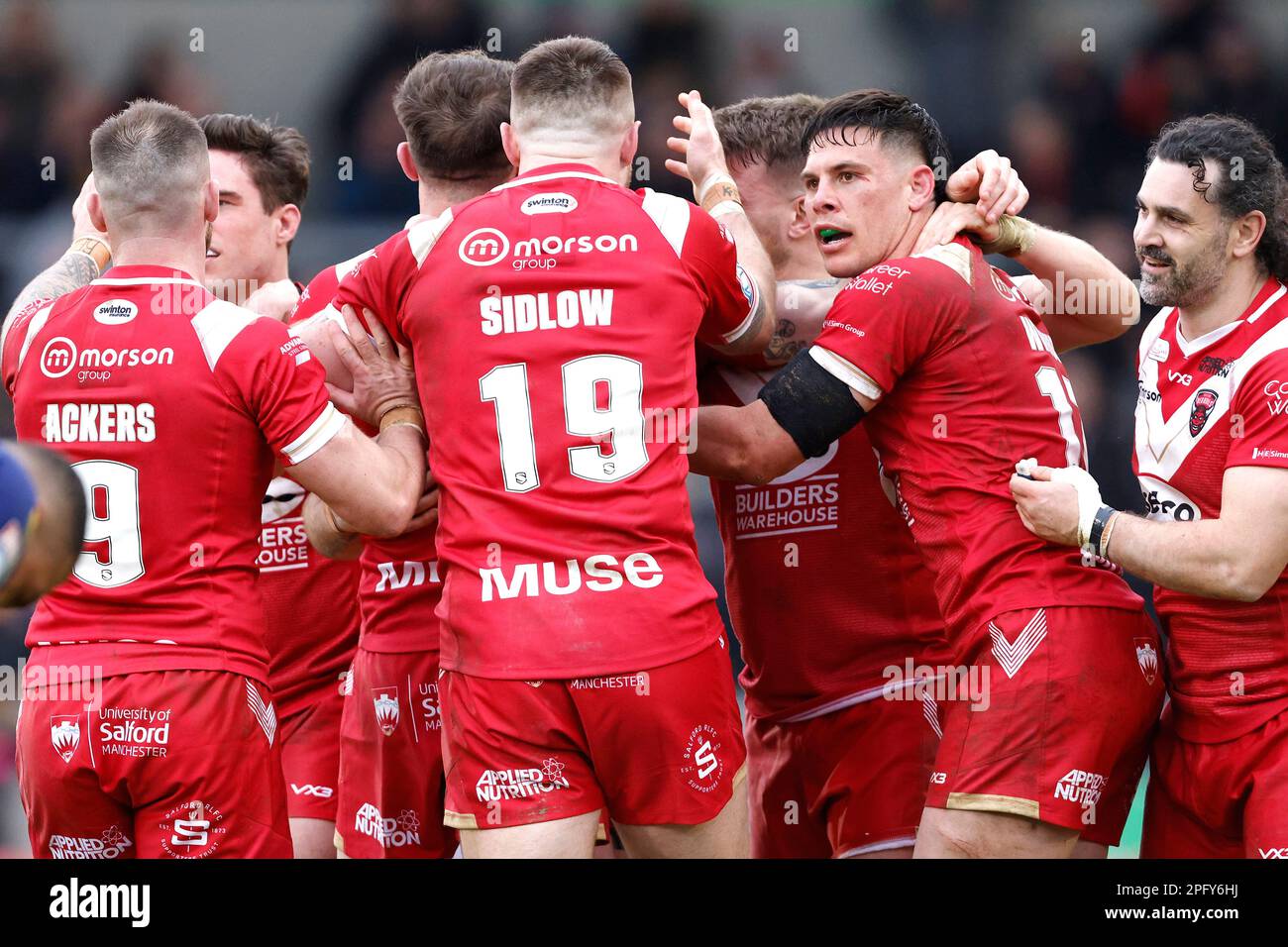 Salford Red Devils' Marc Sneyd (hidden) celebrates scoring a drop goal ...