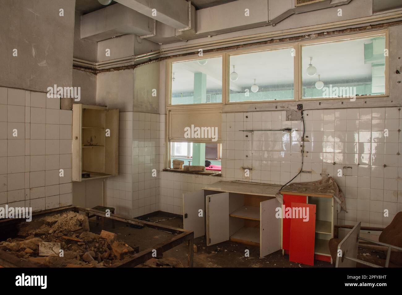 The interior of an abandoned industrial kitchen full of garbage ...