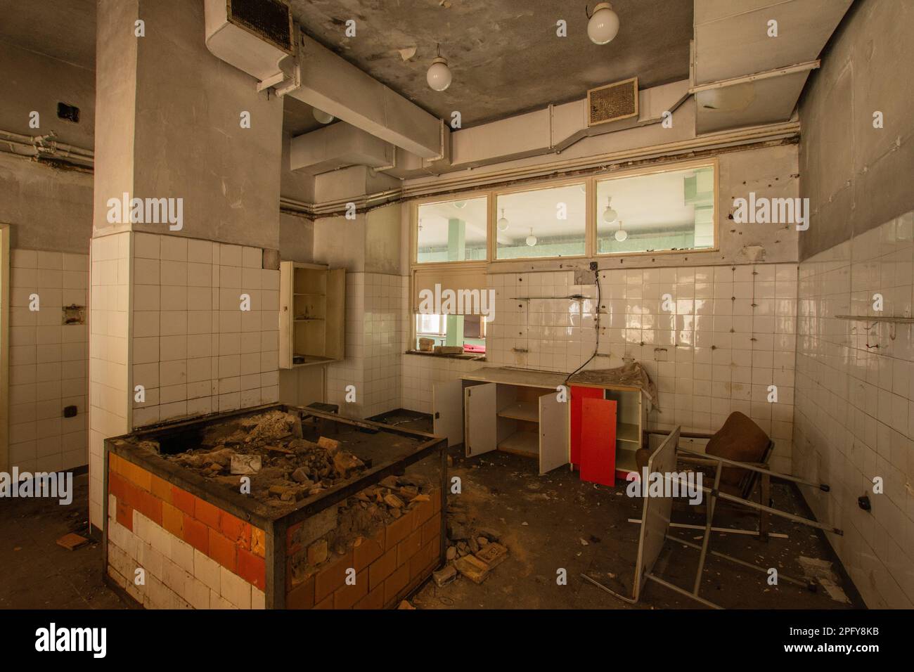 The interior of an abandoned industrial kitchen full of garbage ...