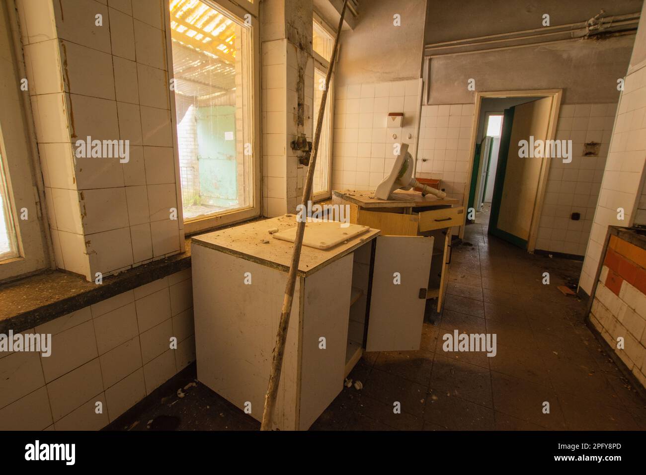 The interior of an abandoned industrial kitchen full of garbage ...