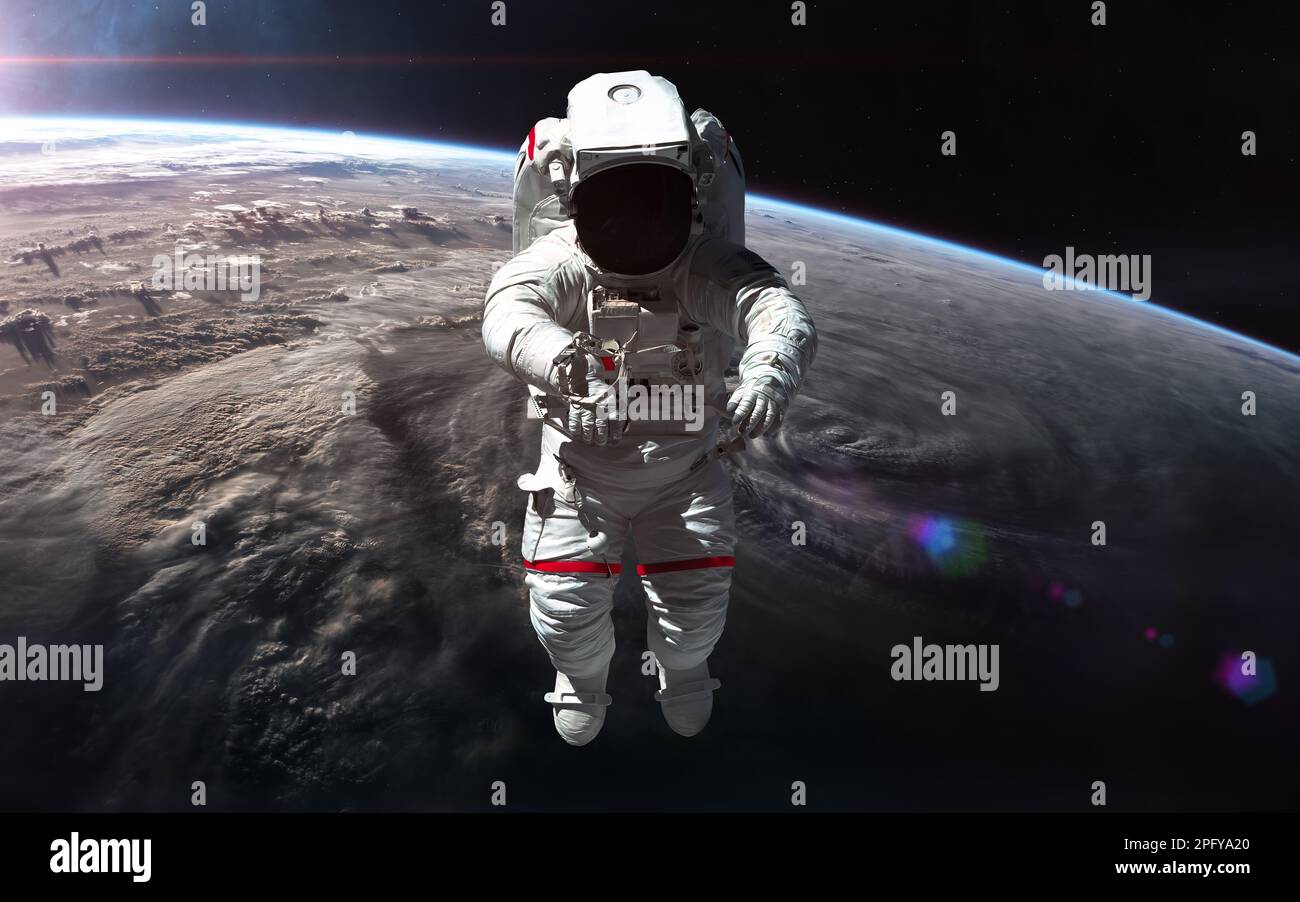 Astronaut in orbit of planet Earth. Solar system Stock Photo - Alamy