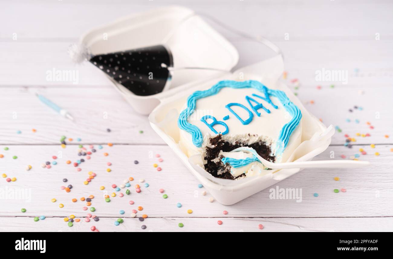 Half eaten birthday bento cake Stock Photo - Alamy