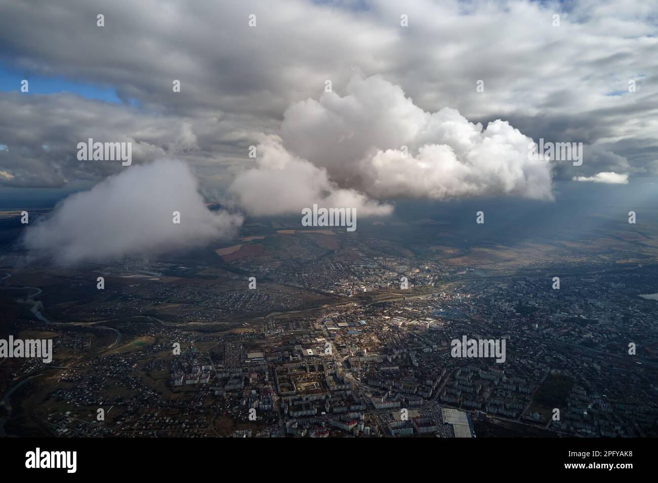 Aerial view from airplane window at high altitude of distant city ...