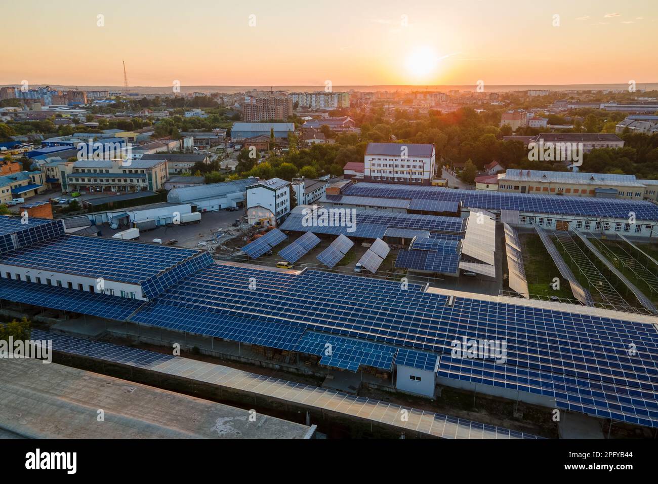 Aerial view of blue photovoltaic solar panels mounted on industrial ...