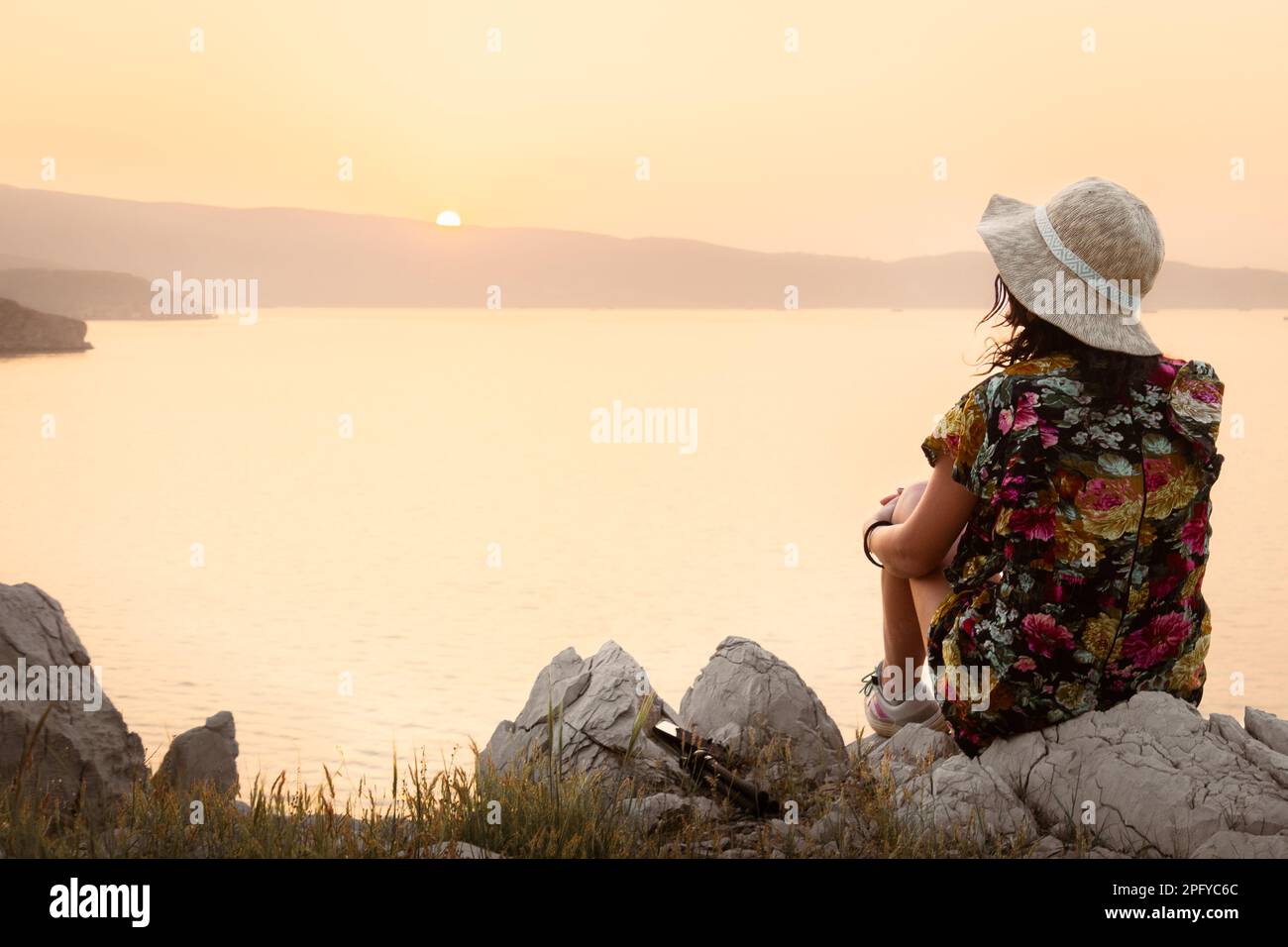 Tourist woman sit enjoy sunset panorama on viewpoint in persian gulf ...