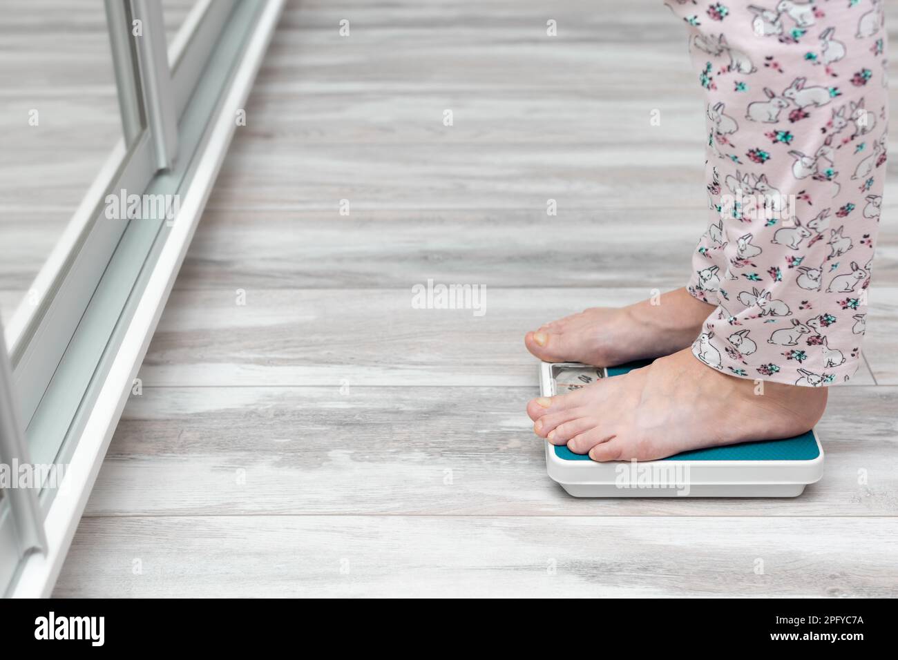 woman stepping on the scales to control her weight. weight loss and ...