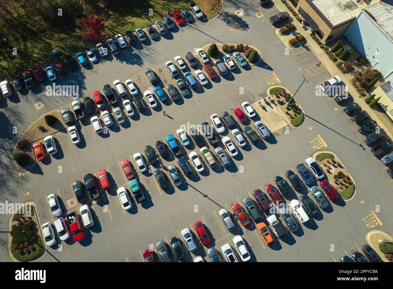 Aerial view of large parking lot with many parked colorful cars ...
