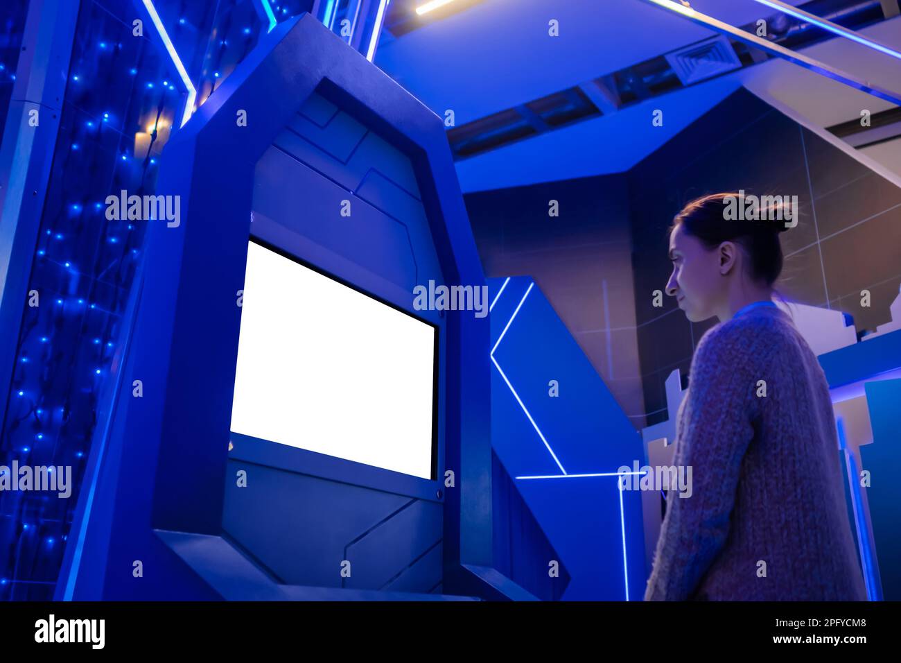White screen concept - woman looking at blank white display kiosk at ...