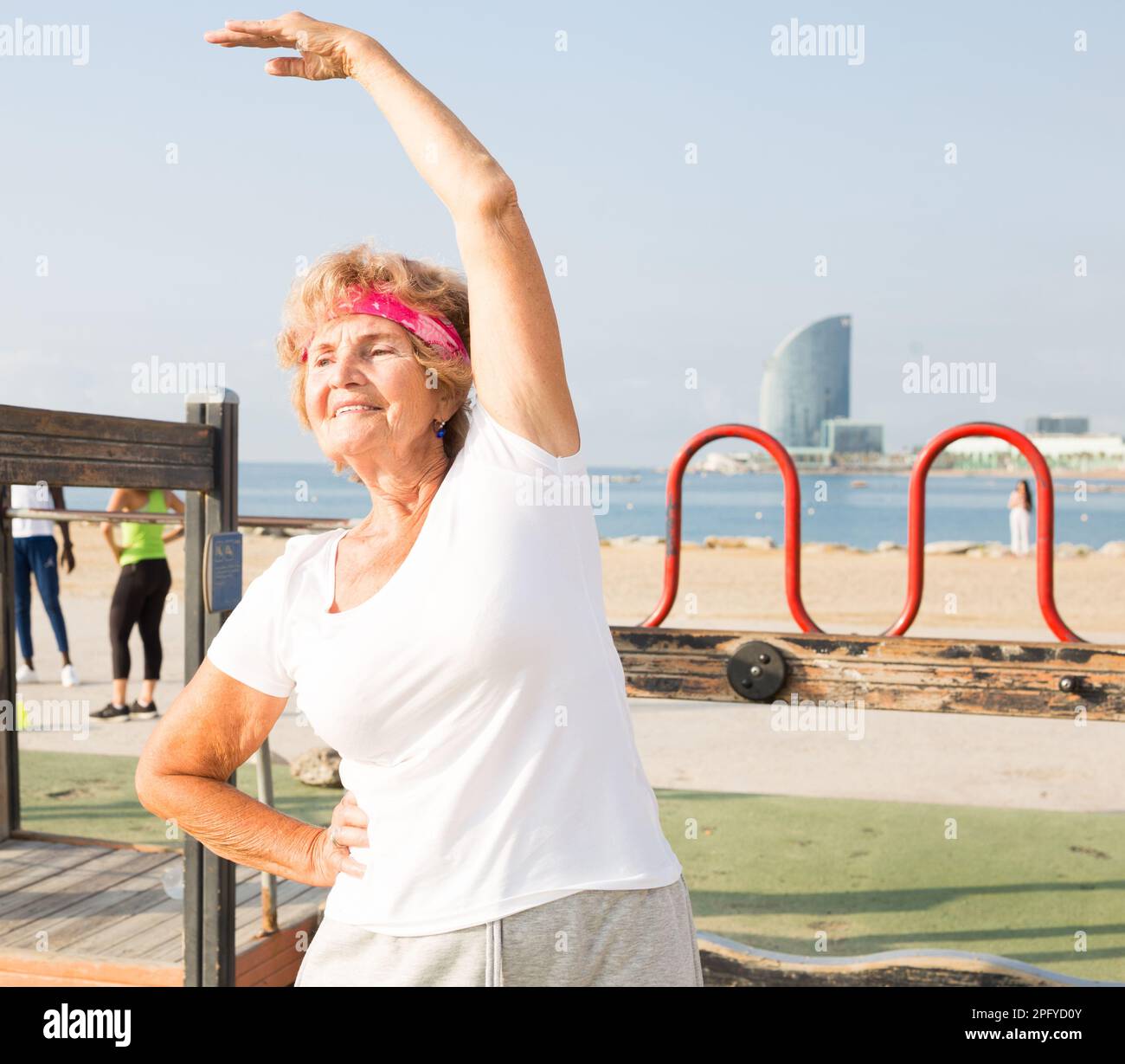 Mature woman doing exercises outdoors Stock Photo - Alamy