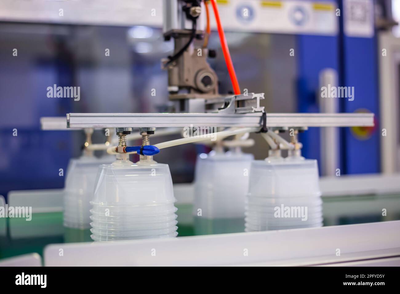 Stack of food containers on conveyor belt of plastic injection molding ...